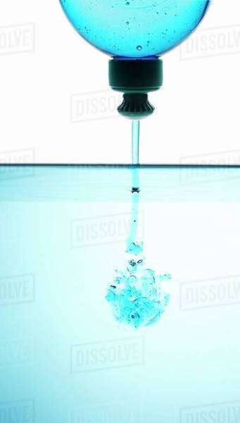 Blue washing-up liquid running into water - Royalty-free Stock Photo ...