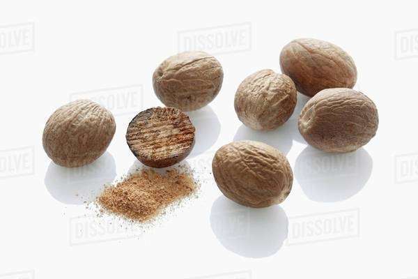 Whole nutmegs and ground nutmeg - Royalty-free Stock Photo | Dissolve