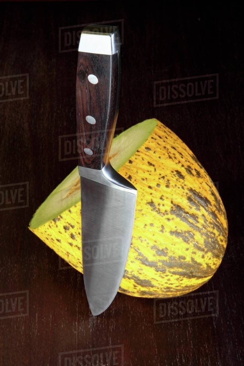 Melon and a knife - Stock Photo - Dissolve