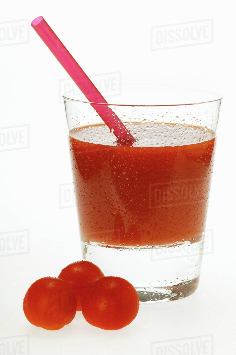 Tomato juice in glass with straw; fresh cherry tomatoes - Stock Photo ...