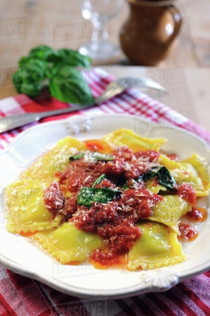Spinach and ricotta filled ravioli pasta with tomato and fresh basil ...