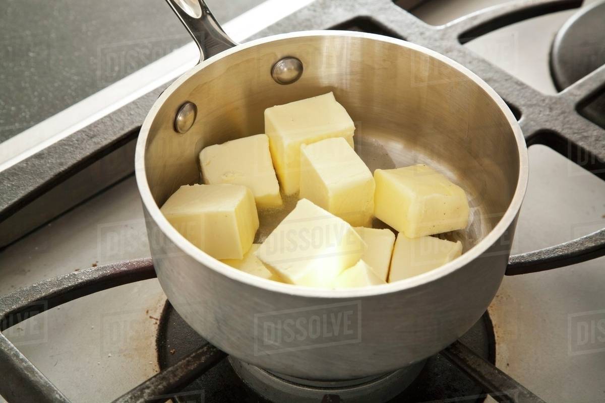 Cubes of Butter in a Pot on the Stove for Melting - Stock Photo - Dissolve