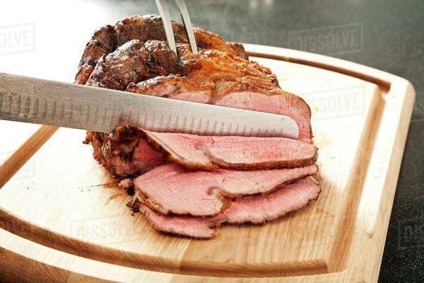 Slicing Prime Rib on a Cutting Board - Royalty-free Stock Photo | Dissolve
