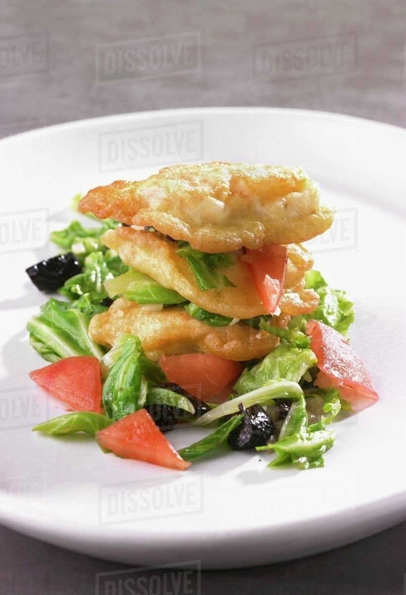 Baked monk fish with bok choy, tomatoes and olives - Stock Photo - Dissolve