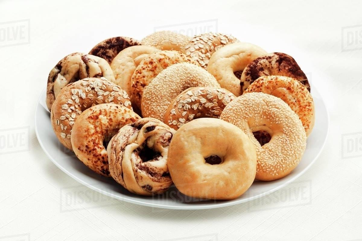 Variety of Bagels on a Platter; White Background - Stock Photo - Dissolve