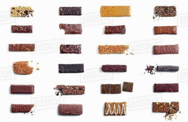 Large Assortment of Granola Bars on White Background; Some Crumbled and ...
