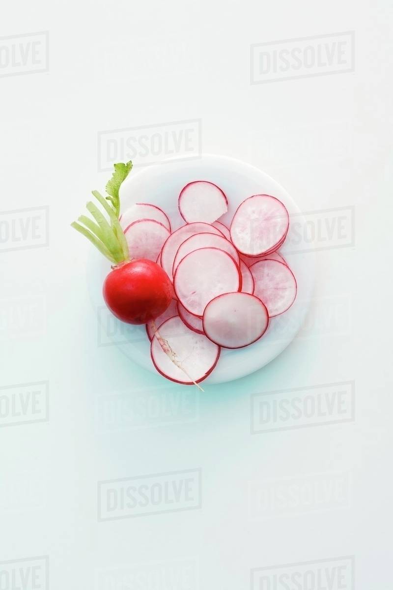 A whole radish and sliced radishes - Royalty-free Stock Photo | Dissolve