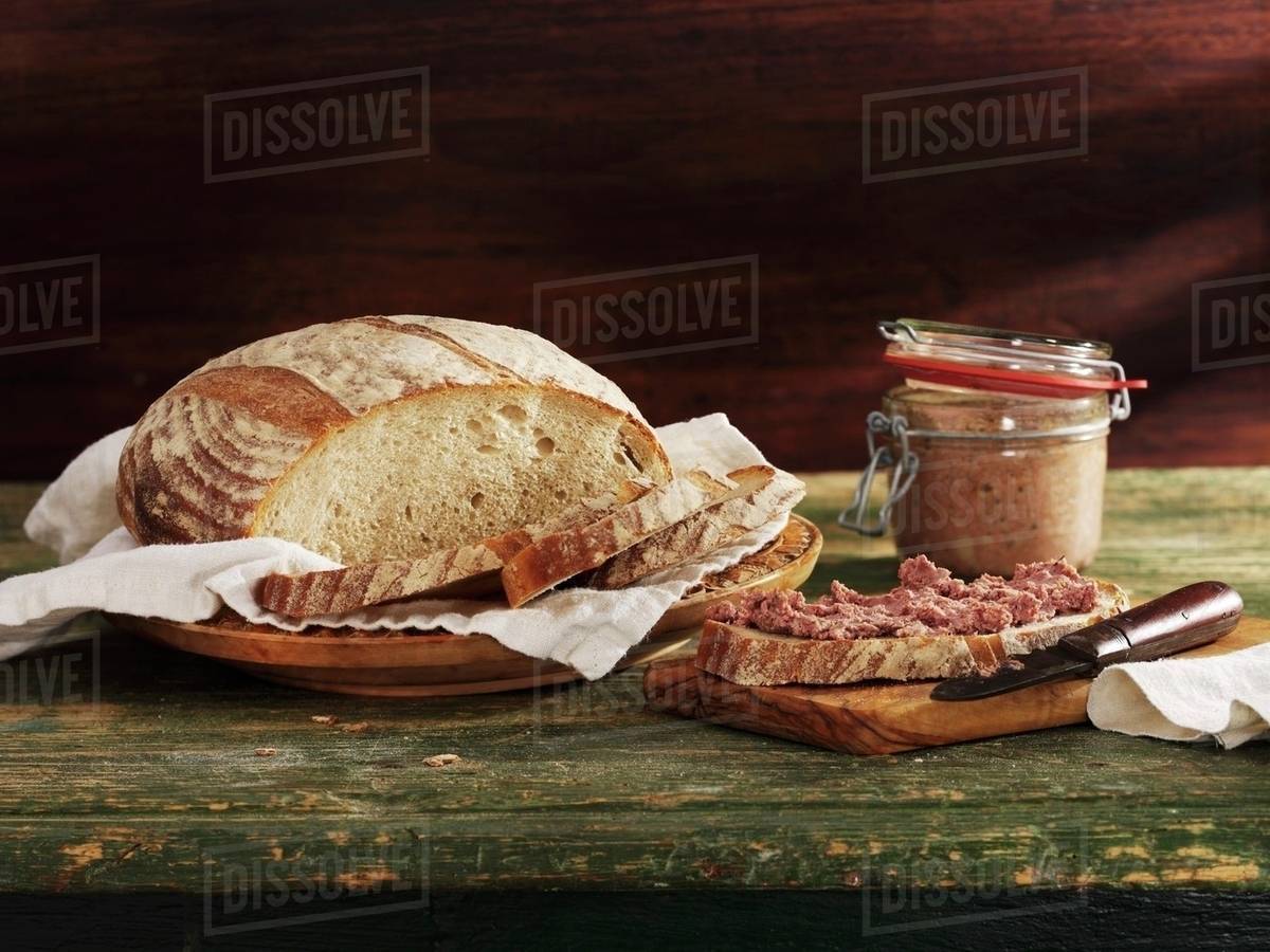 Cut rustic loaf and slice of bread with spread - Royalty-free Stock ...