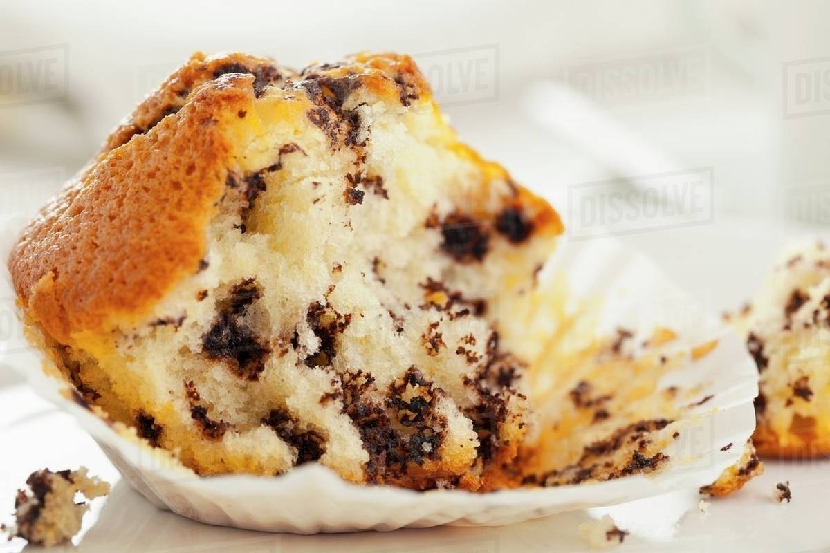 A half-eaten chocolate chip muffin - Stock Photo - Dissolve