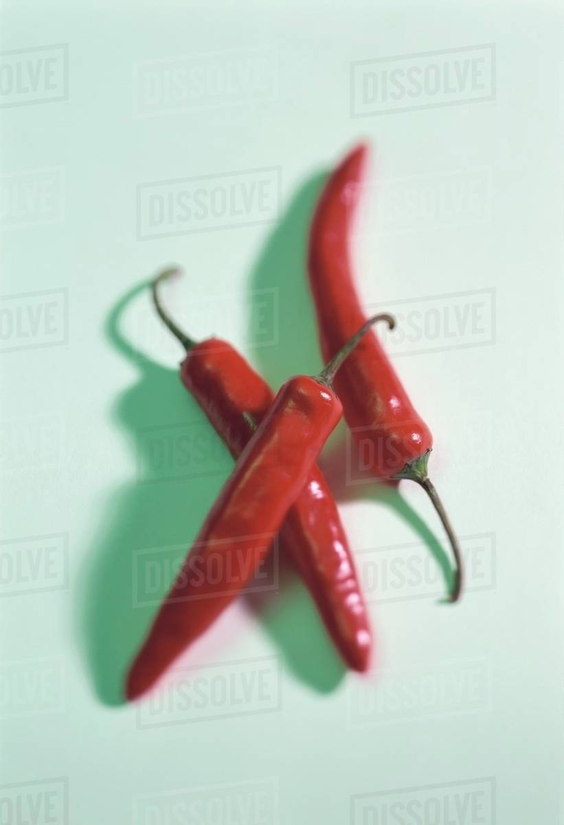 Three red chillies - Stock Photo - Dissolve