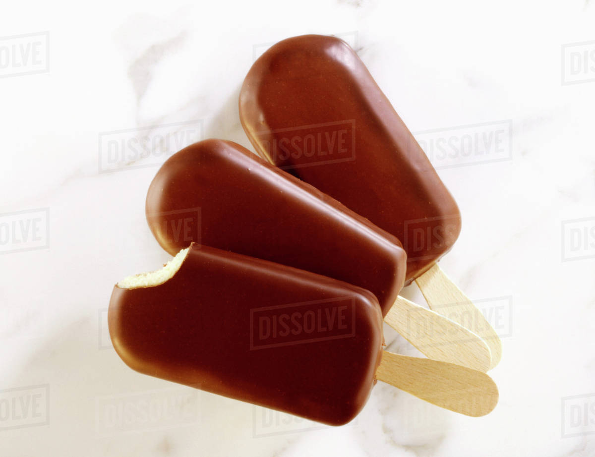 Chocolate-coated vanilla ice on stick - Royalty-free Stock Photo | Dissolve