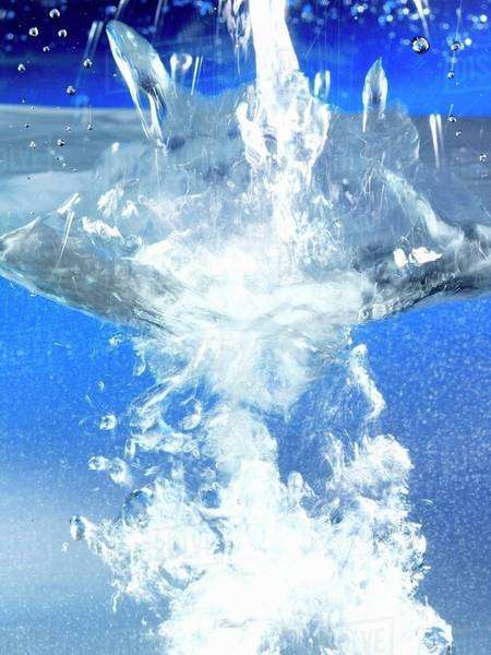 Jet of water entering water - Royalty-free Stock Photo | Dissolve