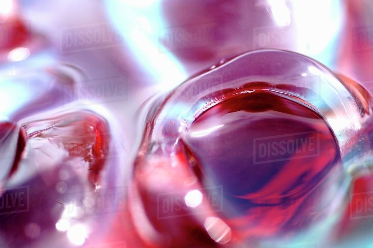 Ice cubes in red fruit juice - Stock Photo - Dissolve