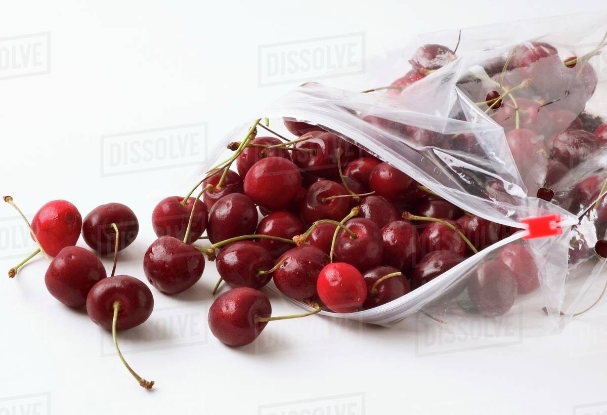 Cherries falling out of a plastic bag - Royalty-free Stock Photo | Dissolve