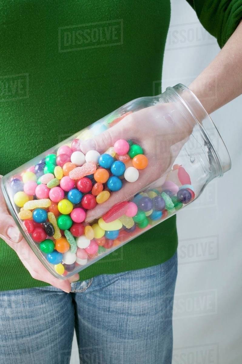 Hand taking bubble gum out of jar - Royalty-free Stock Photo | Dissolve