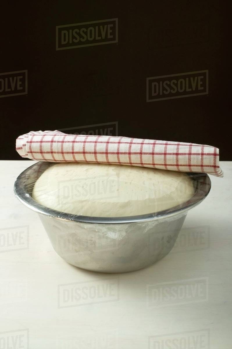 Leaving pizza dough to rest in bowl - Royalty-free Stock Photo | Dissolve