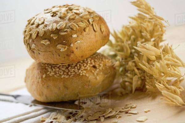 Sesame roll & wholemeal roll with oat flakes, cereal ears - Stock Photo ...