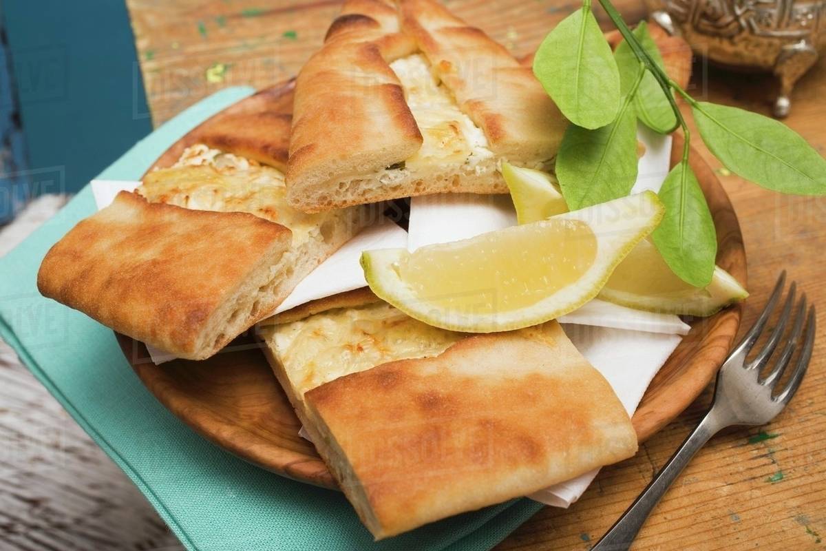 Pide (Turkish flatbread) with sheep's cheese filling - Stock Photo ...