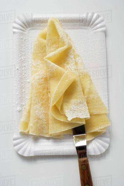 Wafer-thin crepes with icing sugar on paper plate - Royalty-free Stock ...