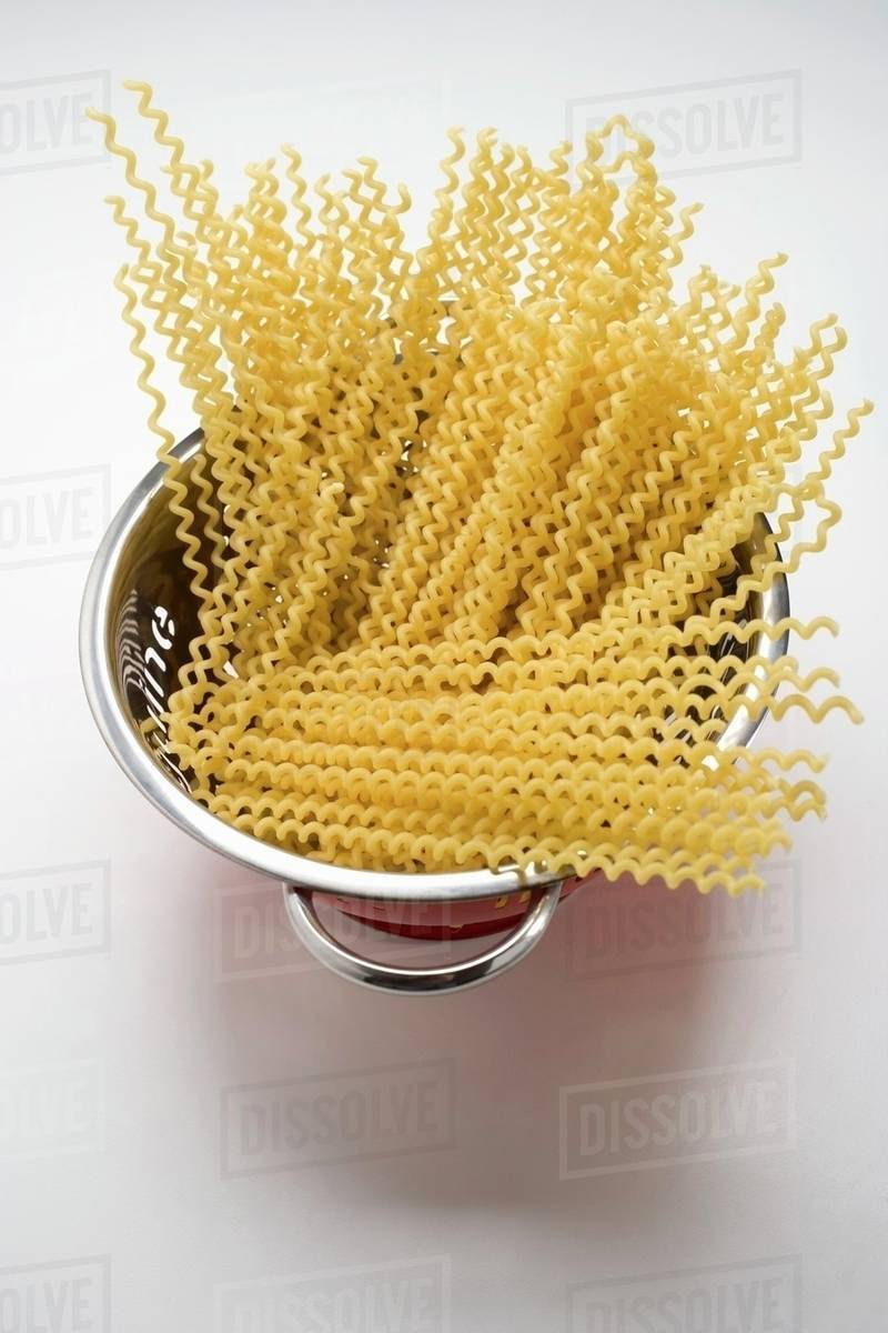 Fusilli lunghi (long pasta spirals) in colander - Royalty-free Stock ...