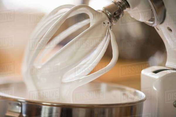 Whipped cream on balloon whisk of food mixer - Royalty-free Stock Photo ...