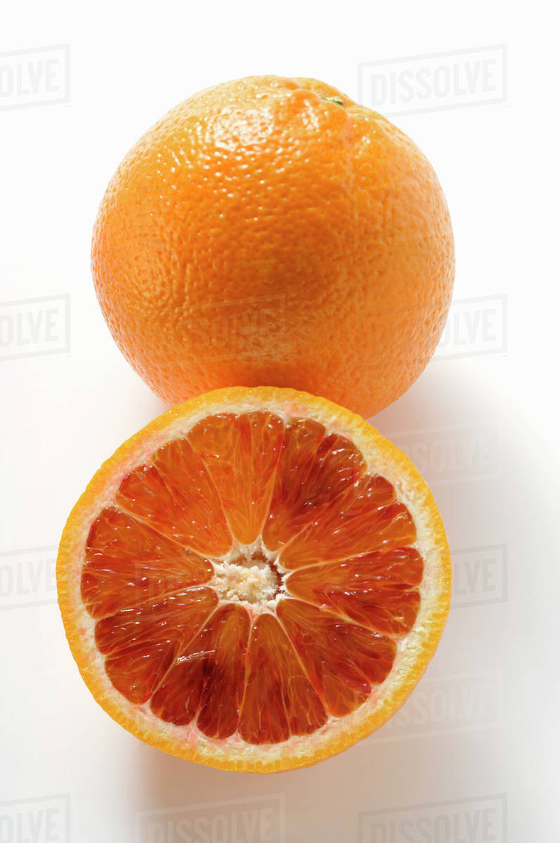 A whole and a half of a blood orange - Royalty-free Stock Photo | Dissolve