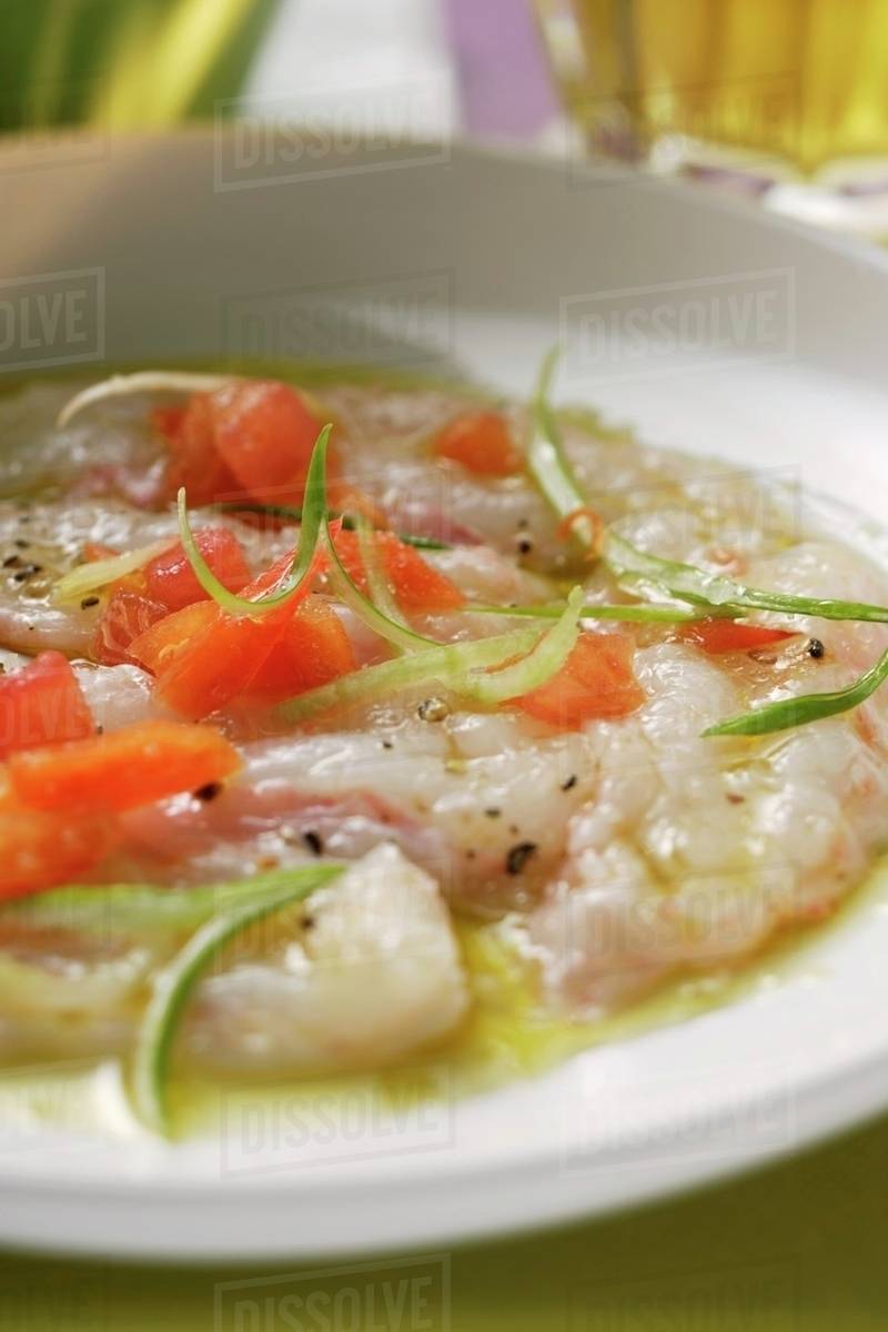 Carpaccio of raw shrimps, tomatoes and spring onions - Stock Photo ...