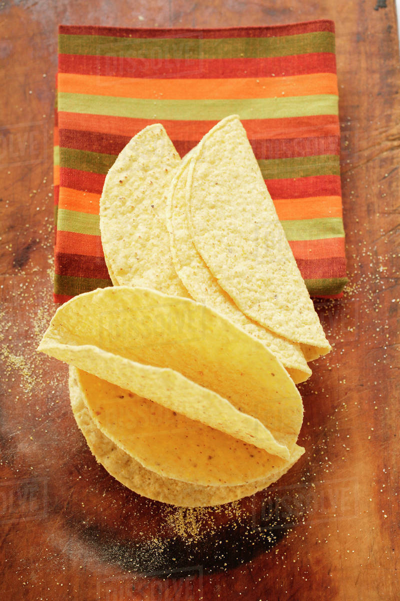 Taco shells in front of striped cloth - Royalty-free Stock Photo | Dissolve