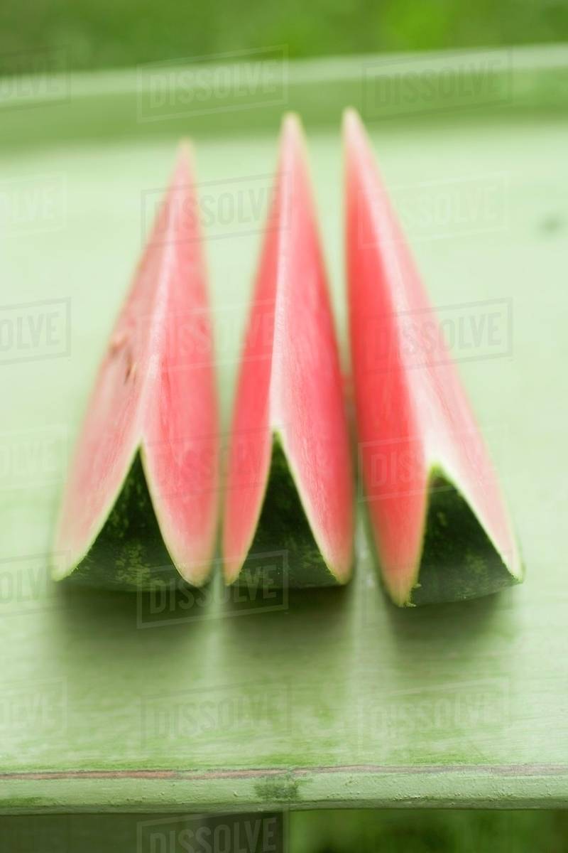 Three wedges of watermelon on green table - Royalty-free Stock Photo ...