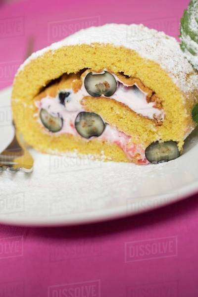 A slice of sponge roulade with berry & quark filling - Royalty-free ...