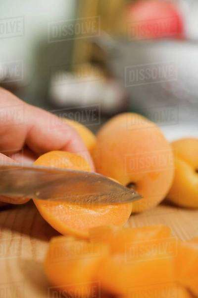 Cutting up apricots - Stock Photo - Dissolve