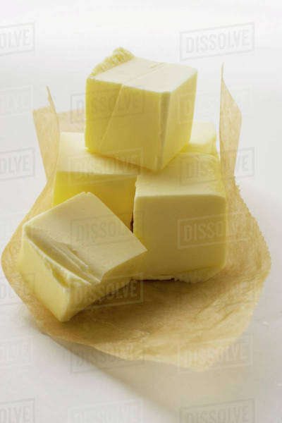 Cubes of butter on paper - Royalty-free Stock Photo | Dissolve