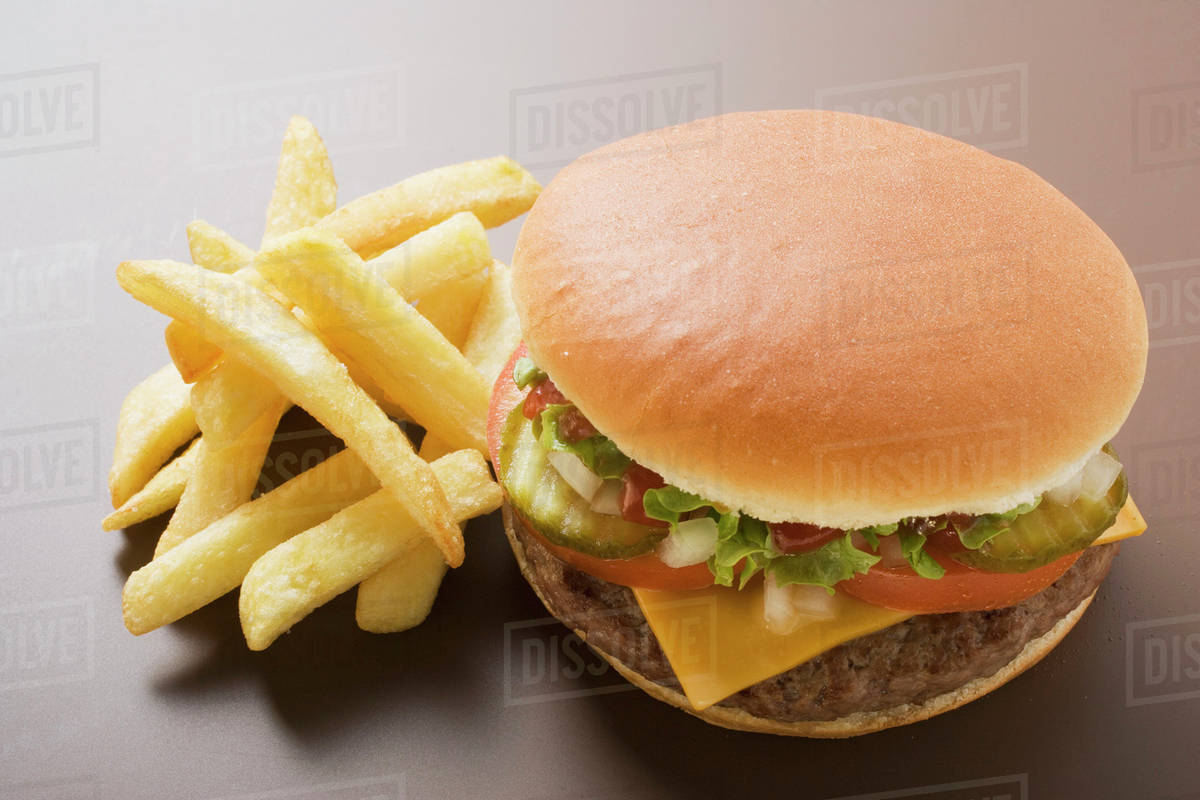 Cheeseburger with chips - Royalty-free Stock Photo | Dissolve