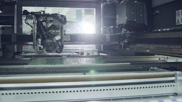 Surface Mount Technology (SMT) Machine places resistors, capacitors ...