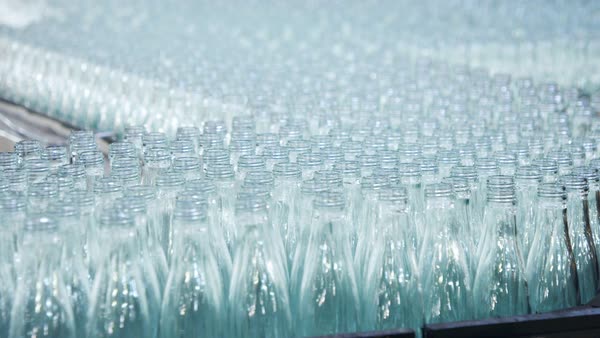 Glass bottles production. Glass bottles on a conveyor belt in an ...