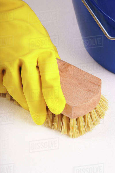 Person scrubbing surface, close-up - Stock Photo - Dissolve