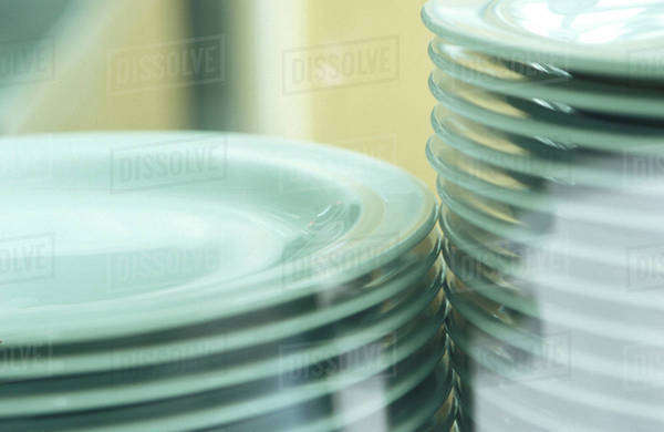 Piled plates, close-up - Stock Photo - Dissolve