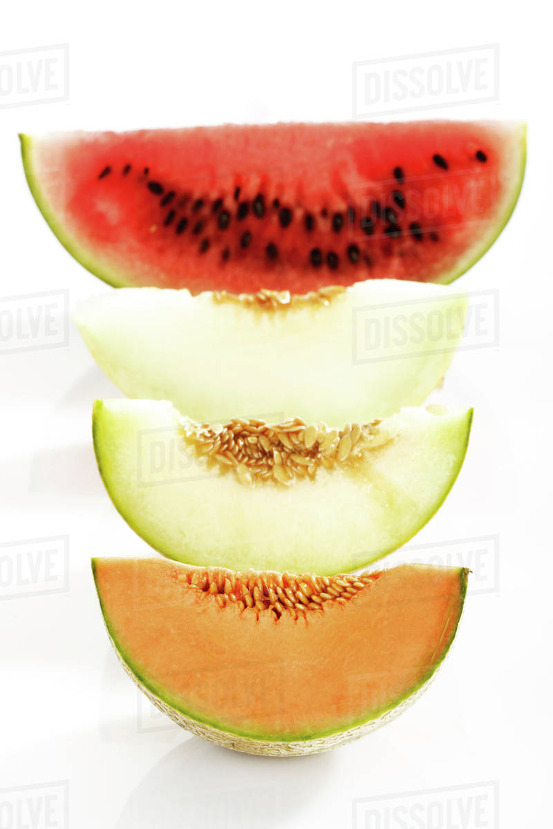 Various sliced melons, elevated view - Stock Photo - Dissolve