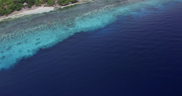 Flight over beautiful Pacific Ocean coast line with deep blue water and ...