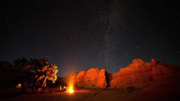 Time lapse of campsite in the Utah desert at night viewing red rock lit ...