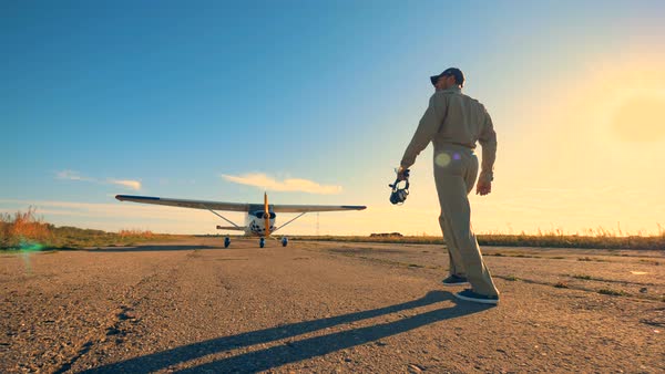 Pilot walking on a runway and checking an airplane, Kazan, Russia ...