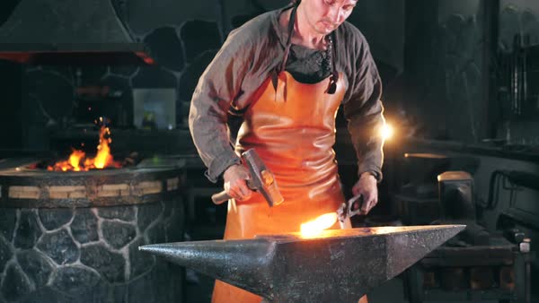 Male worker is hammering iron in slow motion - HD Royalty-free Stock ...