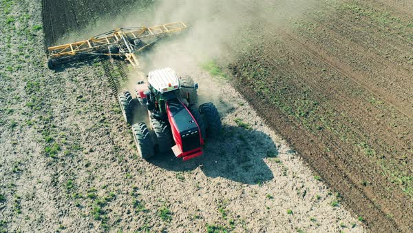 Plowing tractor works on a big field. - 4K Royalty-free Stock Video ...