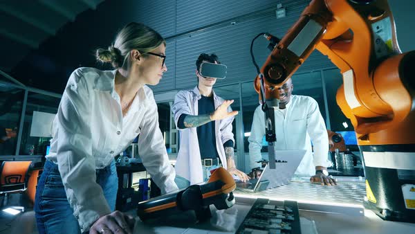 Team of IT engineers are using VR-glasses to operate robots - 4K ...