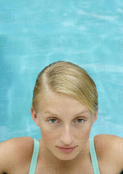 Young woman, head and shoulders, pool water in background - Royalty ...