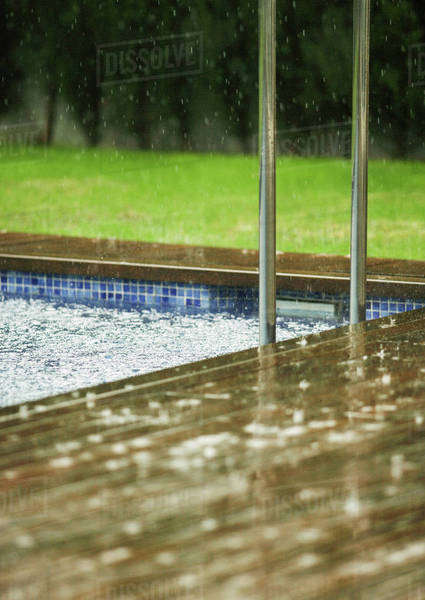 Swimming pool in rain - Stock Photo - Dissolve