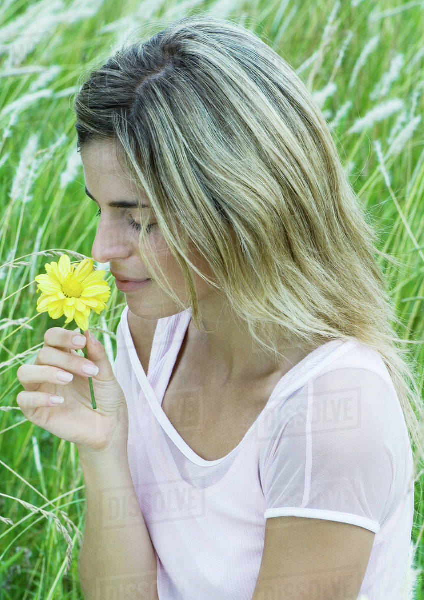 Woman smelling flower - Royalty-free Stock Photo | Dissolve