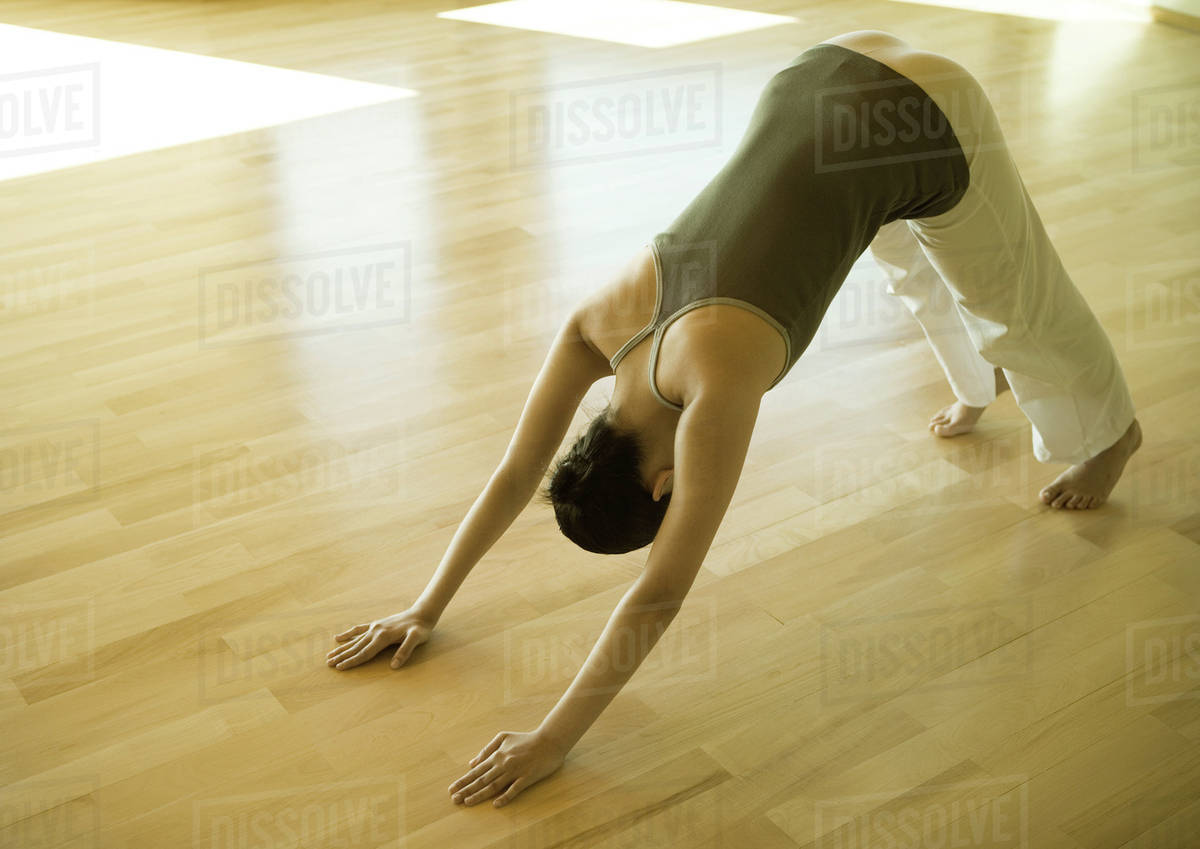 Woman doing downward dog pose - Royalty-free Stock Photo | Dissolve