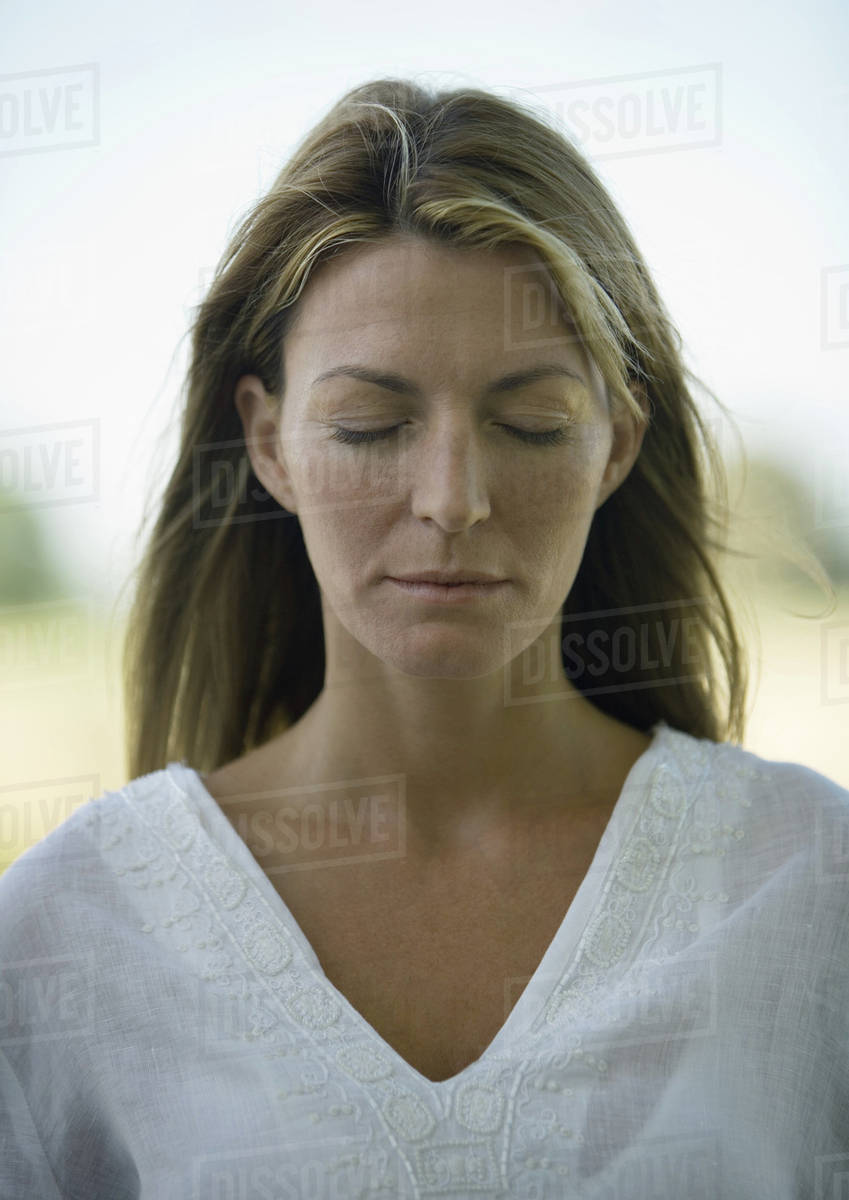 Woman with eyes shut, portrait - Royalty-free Stock Photo | Dissolve