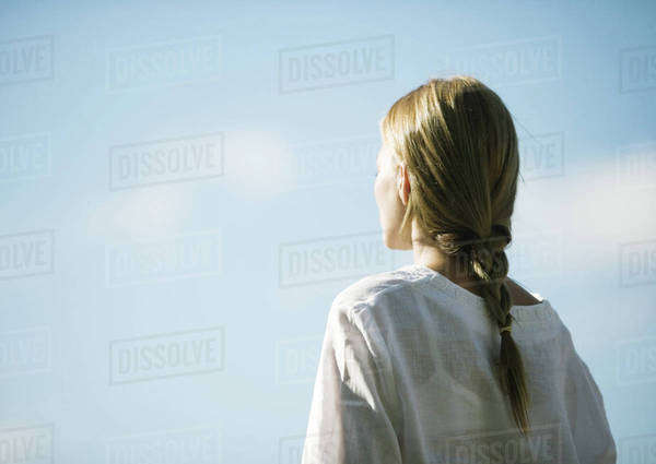 Woman facing sky, rear view - Royalty-free Stock Photo | Dissolve